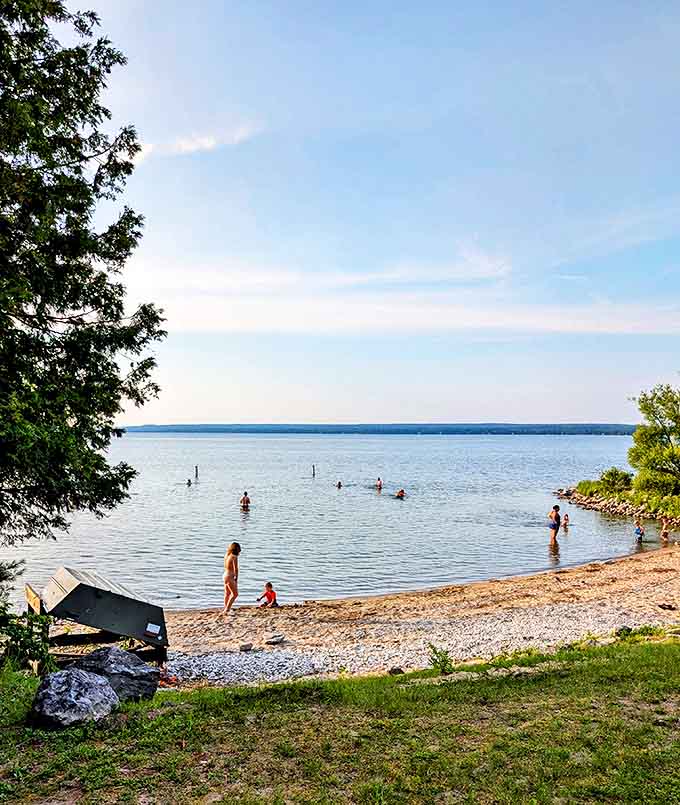 Beach day perfection: Where pristine waters meet pebbly shores, creating the kind of swimming spot that makes you forget about tropical vacations.