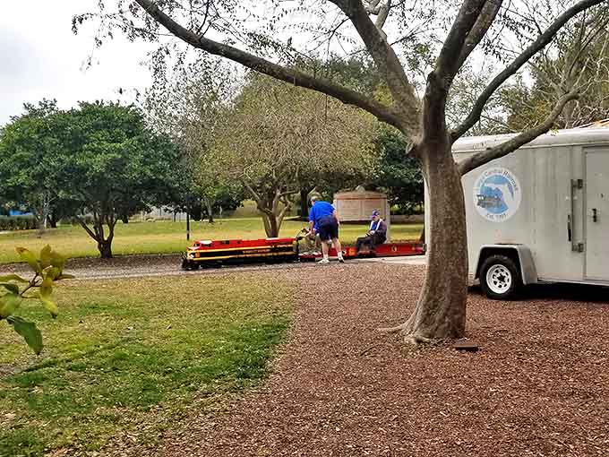 Volunteers prepare a train for its journey, showcasing the behind-the-scenes dedication that keeps this community treasure running smoothly for decades.