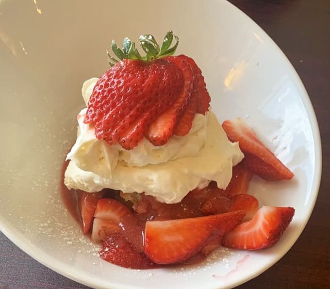 This strawberry shortcake situation looks almost too pretty to eat, but that hesitation lasts approximately three seconds before forks start moving.