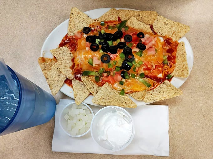 Nachos that don't mess around &ndash; loaded with cheese, olives, tomatoes, and all the fixings for serious snacking.