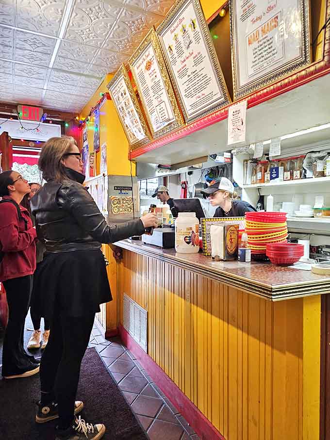 The ordering counter feels less like a transaction and more like being welcomed into someone's quirky, hot-dog-obsessed home &ndash; complete with friendly faces and golden-framed menus.