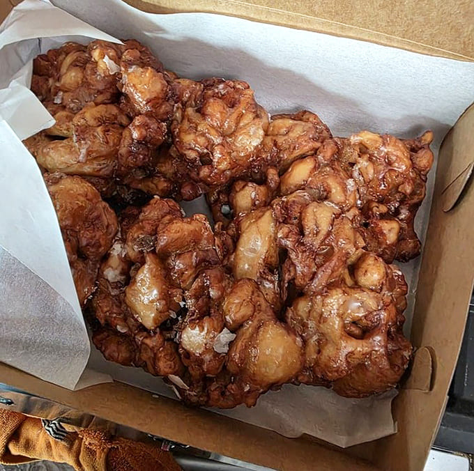 A box full of apple fritters is either breakfast for a week or a really good Tuesday, depending on your level of self-control.