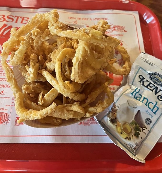 Crispy onion rings stacked high, the perfect accompaniment to seafood feasts and salty ocean breezes.