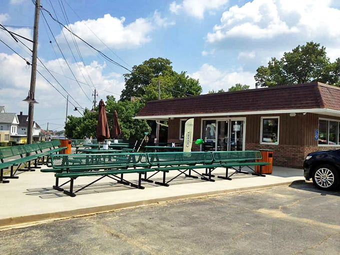 Those green picnic tables aren't just seating – they're community gathering spots where strangers become friends over shared dessert joy.