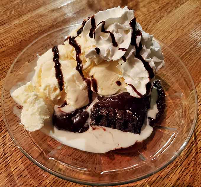 The brownie sundae provides a decadent finale with warm chocolate, cold ice cream, and enough whipped cream to make dentists nervous.