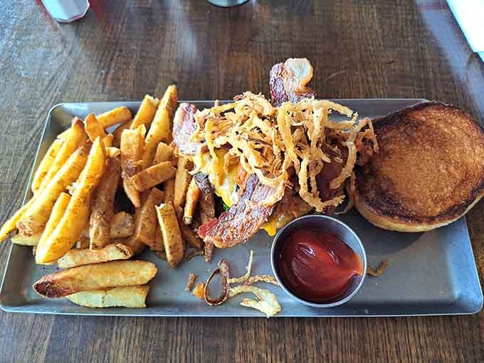 The Pig Out Burger stacks bacon, cheese, and onion strings into a towering monument to excess that's absolutely worth it.