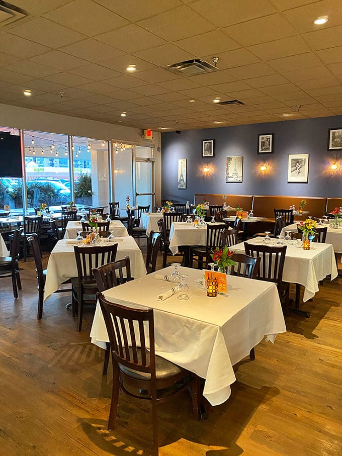 Crisp white tablecloths and warm lighting create the kind of dining space where you actually want to put your phone away.