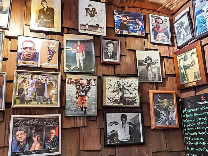 Famous faces and local legends smile down from this visual guestbook, telling stories of meals shared across generations.