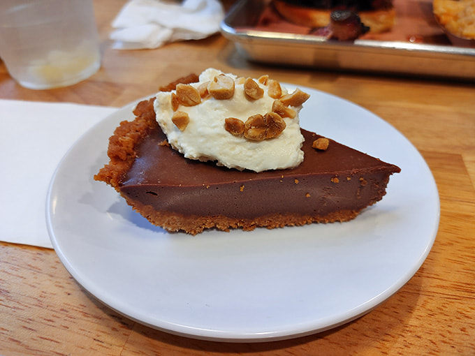 Chocolate peanut butter pie topped with whipped cream and peanuts, because sometimes you need dessert to go big or go home.