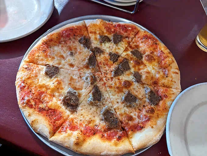 This isn't just pizza, it's a circular canvas of culinary perfection. The cheese-to-sauce ratio would make an Italian grandmother nod in approval.