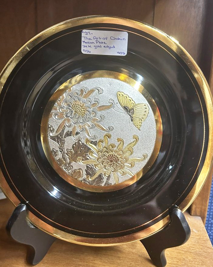 This elegant gold-trimmed china and serving piece await a new home, perhaps destined for a special occasion table or collector's cabinet.
