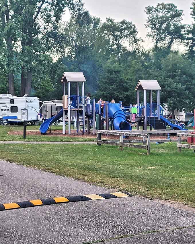 Kids scramble across the playground equipment as camping trailers nestle in the background &ndash; childhood summer memories in the making.