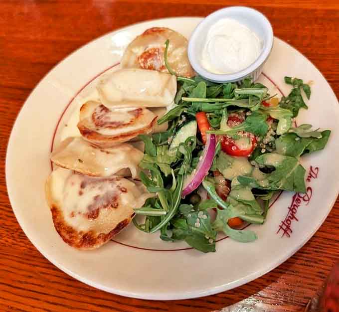 Potato pierogies with sour cream prove that comfort food transcends borders and brings pure joy to every bite.