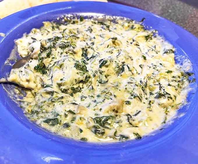 Creamy, cheesy artichoke spinach dip that makes sharing with your tablemates feel like an act of true generosity.
