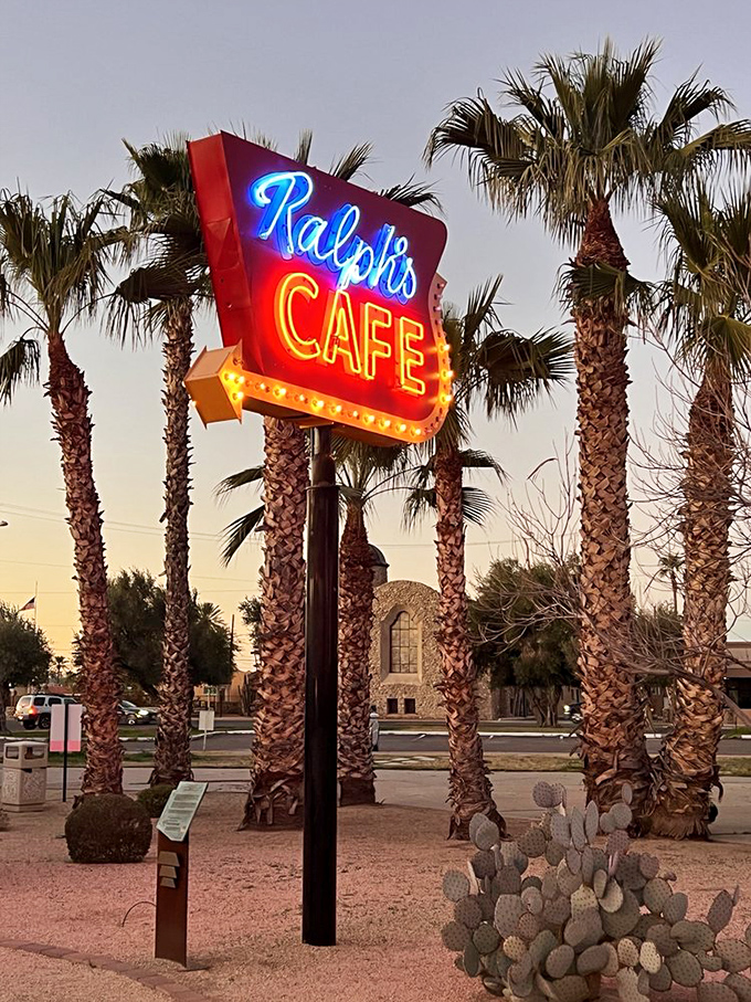 Ralph's Cafe sign, framed by swaying palms, looks like it should be accompanied by the clinking of coffee cups and the sizzle of bacon on a well-seasoned griddle.