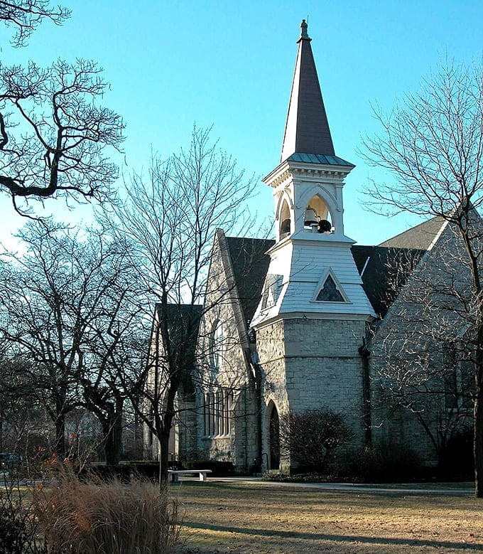 Riverside Presbyterian Church reaches skyward with its elegant spire, a spiritual landmark amid the village's architectural treasures.