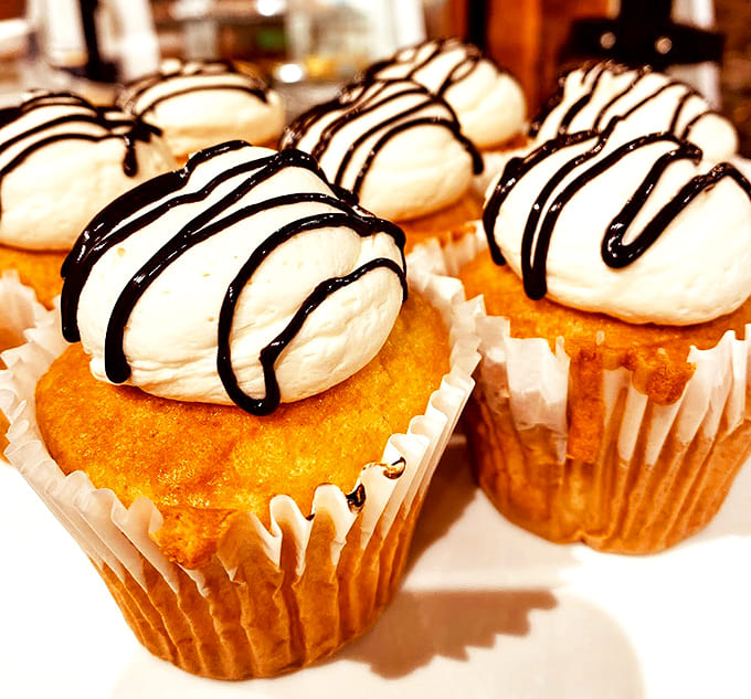 Chocolate bases crowned with pillowy marshmallow frosting and chocolate drizzle &ndash; proof that good things come to those who don't mind sticky fingers.