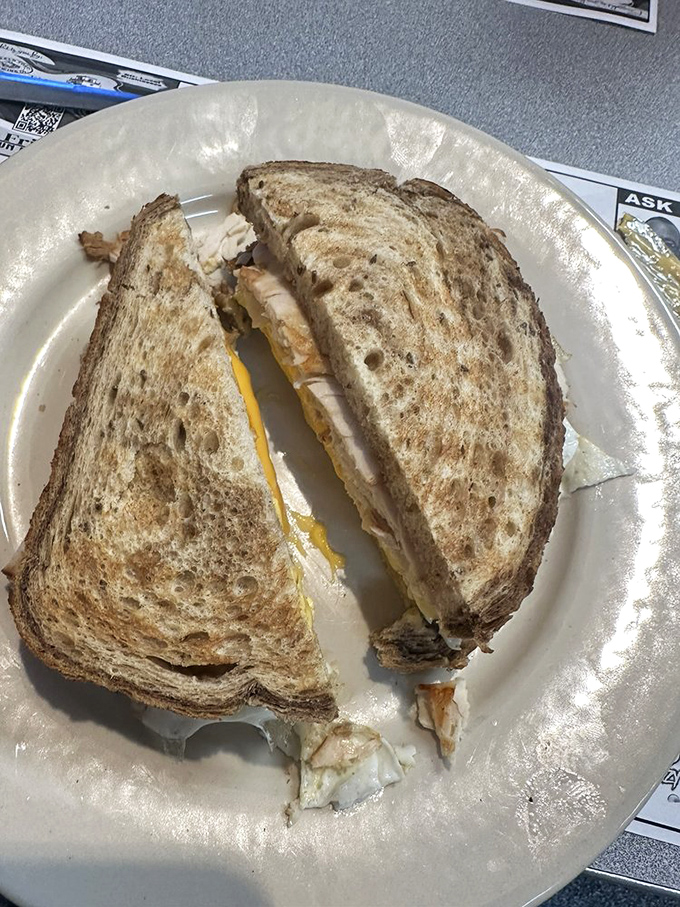 This isn't just a sandwich, it's architectural genius – layers of flavor stacked between perfectly toasted bread.