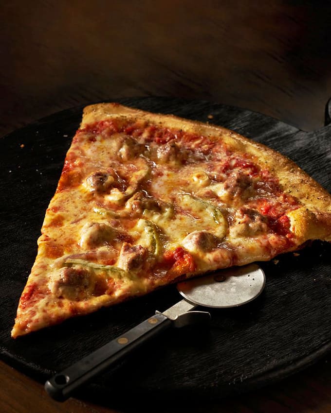 Each sausage slice delivers that perfect New York-style experience &ndash; thin, foldable crust topped with house-made Italian sausage.