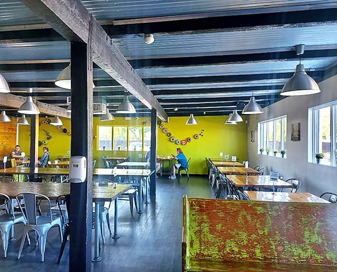 The dining area balances industrial elements with pops of that signature lime green, creating a space that's both trendy and welcoming.