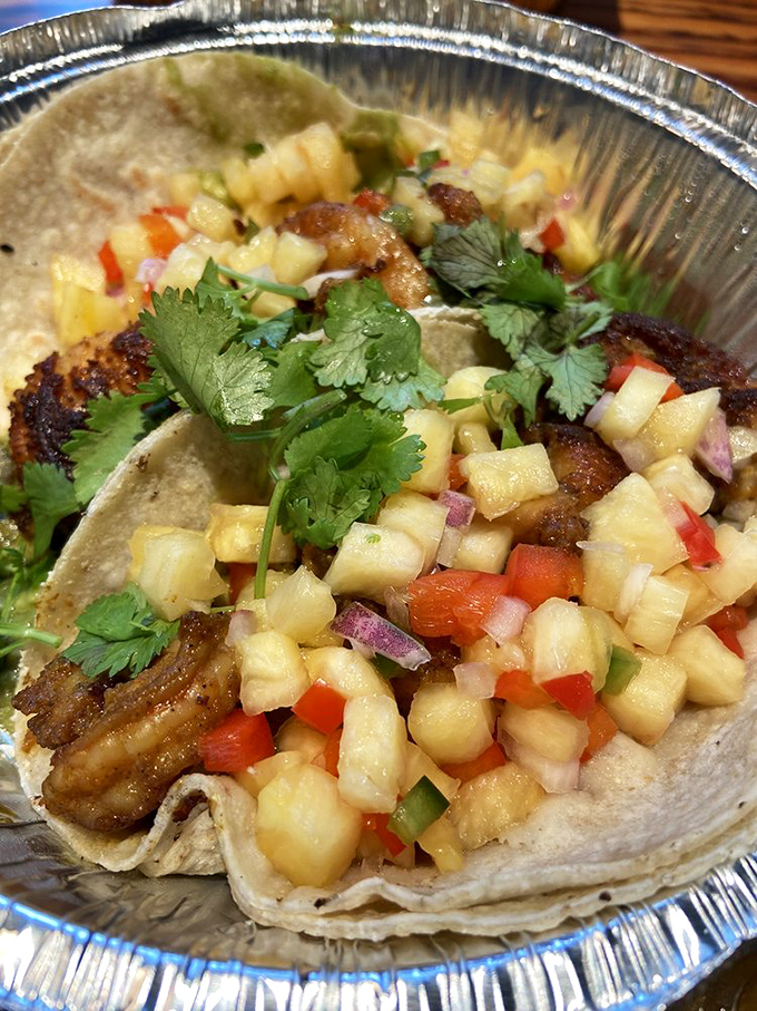 Plump, perfectly cooked shrimp crowned with vibrant pineapple salsa brings unexpected tropical flair to Vermont's mountain landscape.