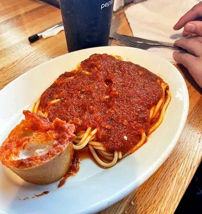 Spaghetti with meat sauce &ndash; a hearty portion of pasta swimming in rich, meaty tomato sauce that tastes like someone's Italian grandmother made it.