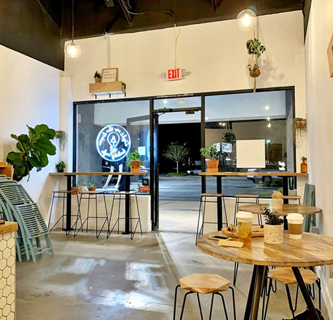 Potted plants add life to the minimalist d&eacute;cor, creating a peaceful oasis for enjoying that well-deserved sugar fix.