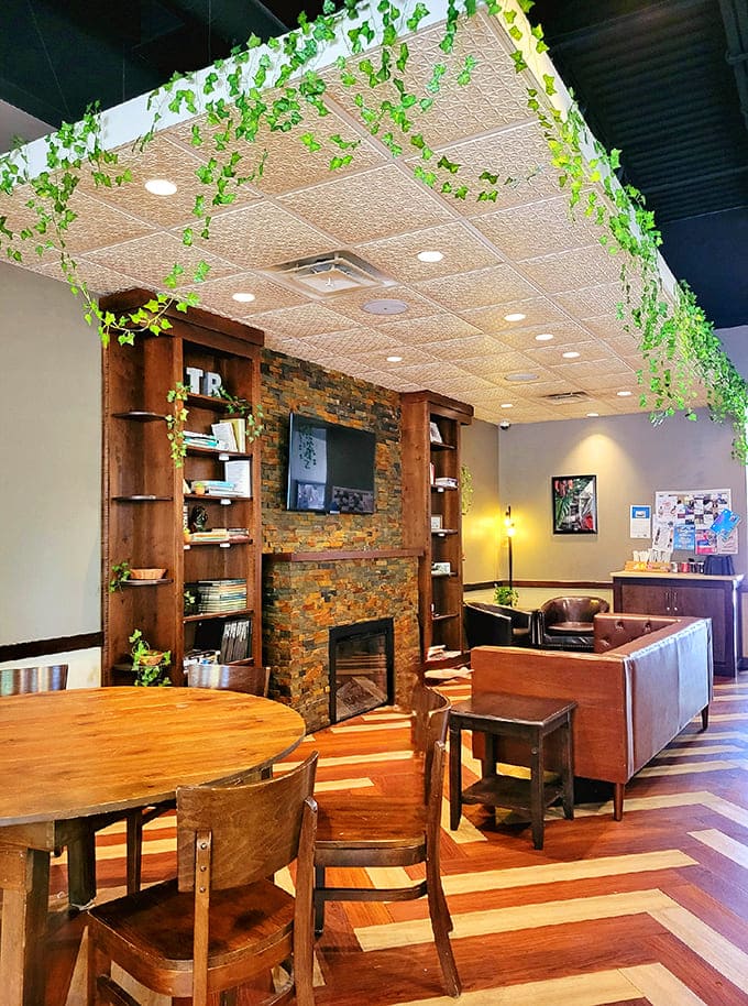 The dining area features a cozy fireplace setup with leather seating, perfect for pretending you're in a much fancier establishment.