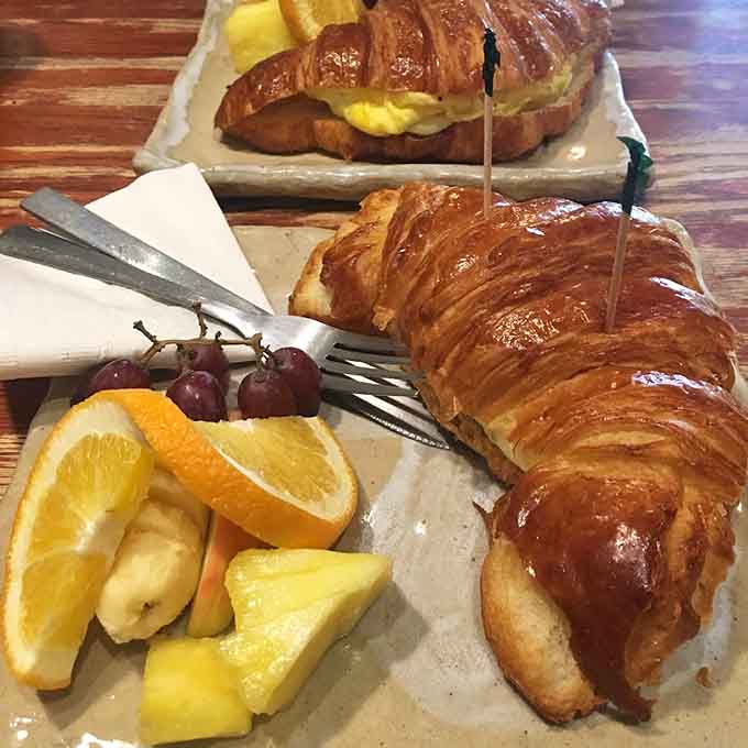 Buttery, flaky croissants served with fresh fruit show the kind of attention to detail that separates good from truly great.