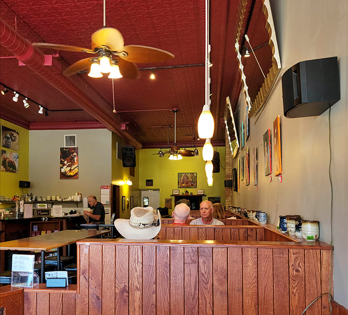 The burgundy ceiling adds unexpected charm to a space where locals gather, proving that great design and great pastries make perfect companions.