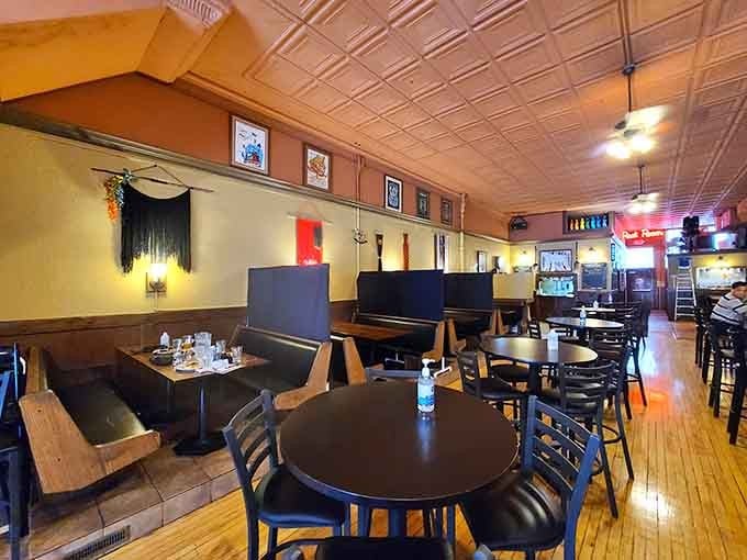 The dining room balances comfort and style, with booths that invite lingering and tin ceilings that add unexpected elegance.