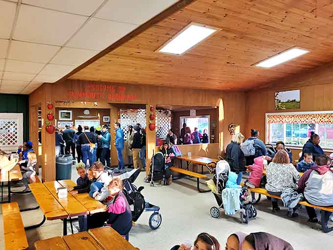 The bustling interior of Plymouth Orchards on a peak autumn weekend &ndash; where families gather to create memories sweeter than the cider they're enjoying.