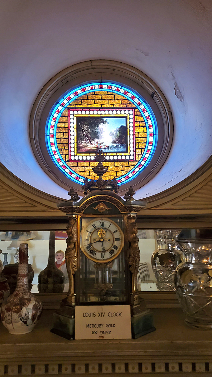 This Louis XIV clock beneath the stained glass window has been keeping time since before America had its own castles to put clocks in.