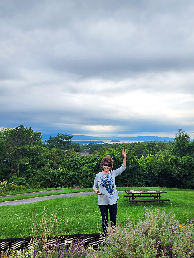 A visitor waves hello, embodying the joy this viewpoint inspires. That smile says it all &ndash; some views simply must be shared.