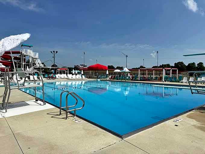 The competition-sized pool gleams in the afternoon sun, offering lap swimmers and cannonball enthusiasts equal opportunity for aquatic joy.