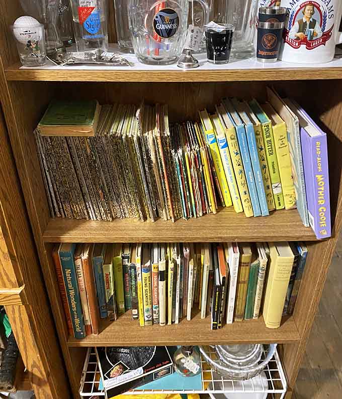 Vintage books and glassware share shelf space, because apparently our grandparents believed in both reading and drinking with style.