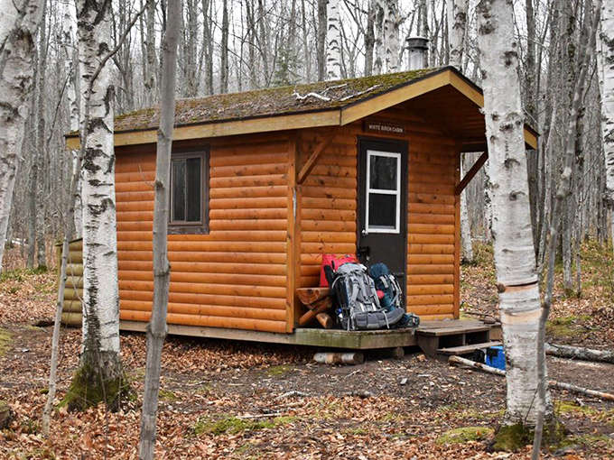 Rustic cabins nestled among white birch trees offer wilderness solitude with just enough comfort &ndash; your own private retreat miles from civilization.