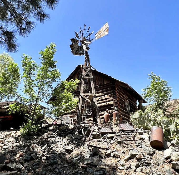 A wooden windmill stands sentinel against the Arizona sky, harnessing desert breezes just as it did a century ago.