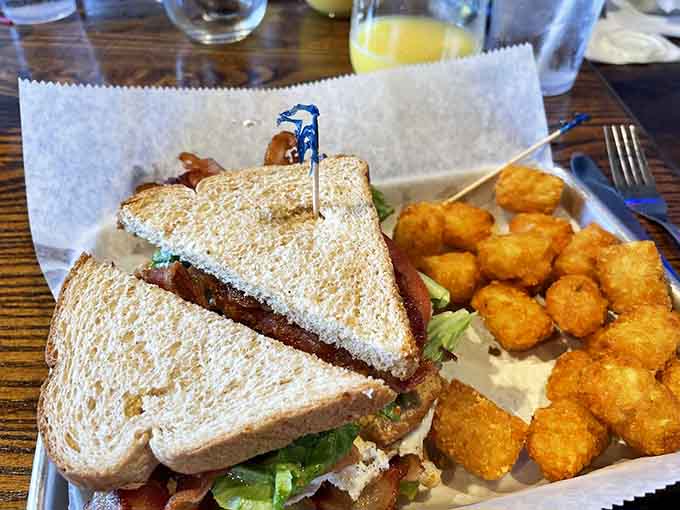 The club sandwich towers impressively with layers of meat, cheese, and crispy bacon throughout.