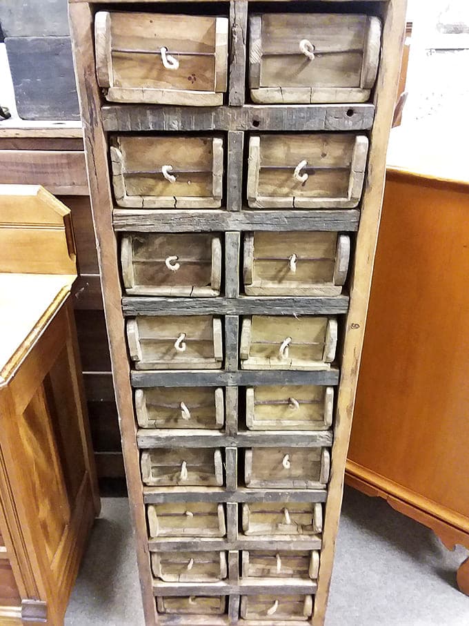 These primitive wooden drawers once organized a shopkeeper's world – now they stand ready to bring rustic character to modern homes seeking authentic history.