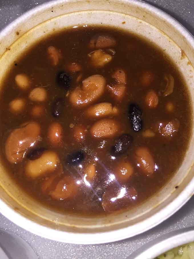 Baked beans swimming with actual brisket pieces, turning a simple side dish into something you'd happily eat as a main course.