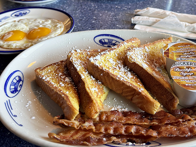 Golden French toast dusted with powdered sugar alongside crispy bacon – sweet and savory harmony that transcends galactic boundaries.