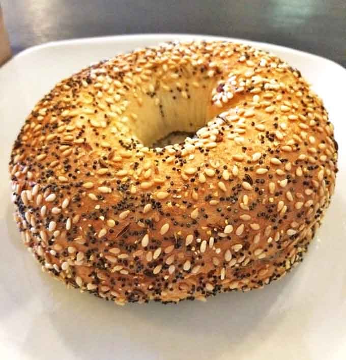 An everything bagel so generously topped, it's like a flavor explosion decided to take circular form.
