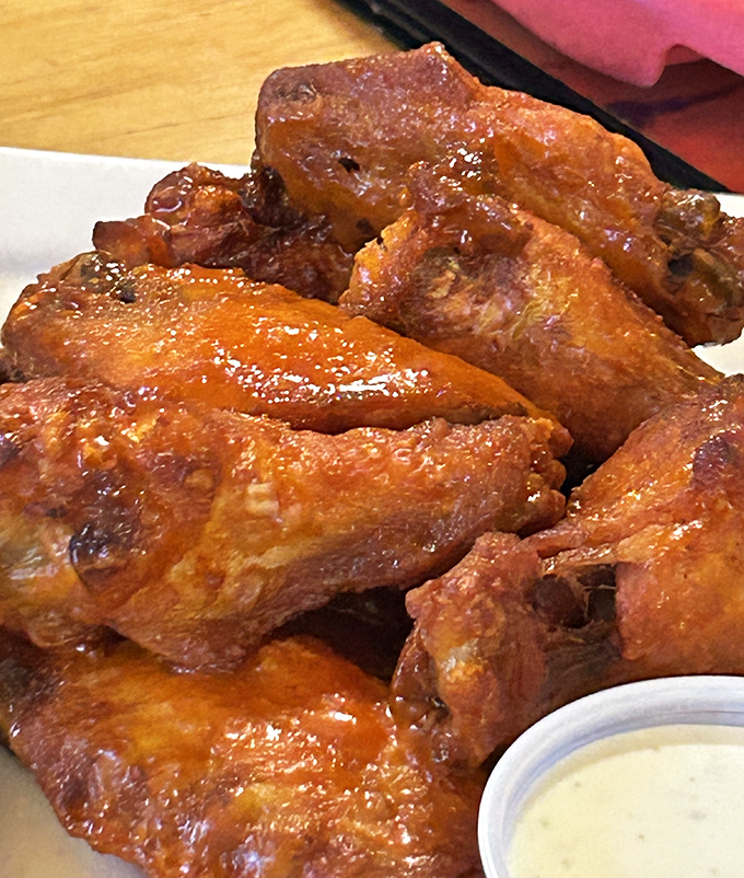 These wings aren't just spicy &ndash; they're a sticky, tangy testament to the kitchen's understanding that good bar food requires no pretension, just perfect execution.