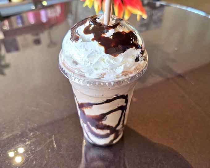 Chocolate drizzle cascading down whipped cream mountains &ndash; this isn't just a milkshake, it's performance art you can slurp.