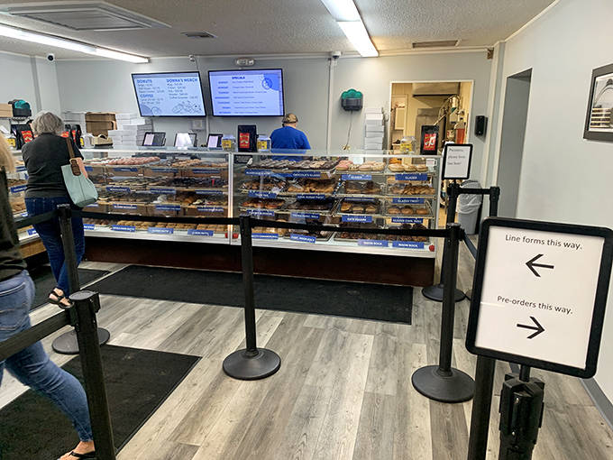 The ordering counter where donut dreams come true, complete with organized lines for those who know exactly what they want.