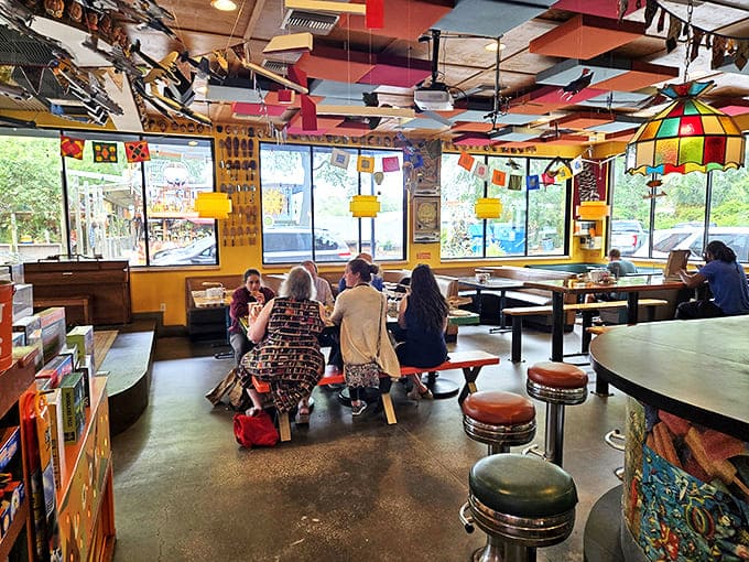 The dining area buzzes with conversation and laughter, proving that good food in a creative space brings people together like nothing else.