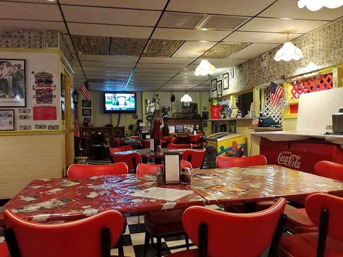 Red vinyl booths and vintage pendant lights create a time-capsule atmosphere where Route 66 nostalgia meets modern culinary innovation.