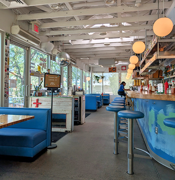 Evening light filters through windows, casting a warm glow across diners enjoying that magical hour when food and conversation flow freely.