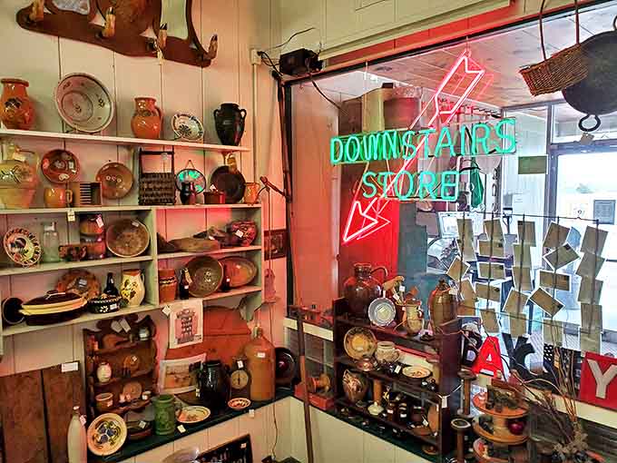 The neon "Downstairs Store" sign glows like a portal to another dimension of vintage delights and retro discoveries.